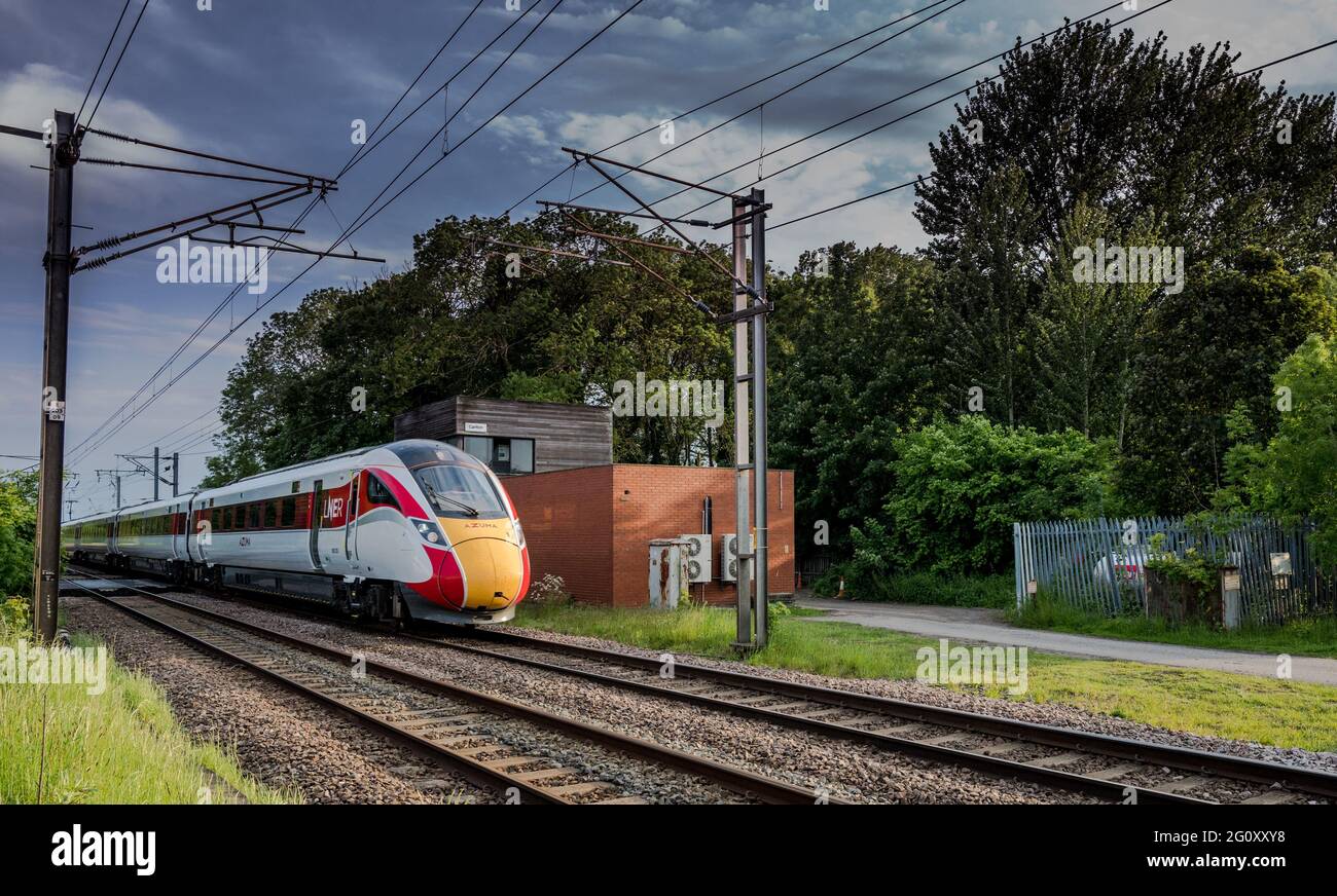 High speed Azuma electrified train passing an auotmatic unmanned level ...