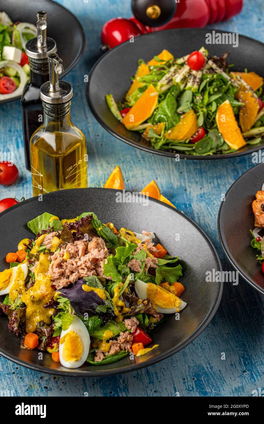 Four different types of salads served freshly on blue stone table Stock ...