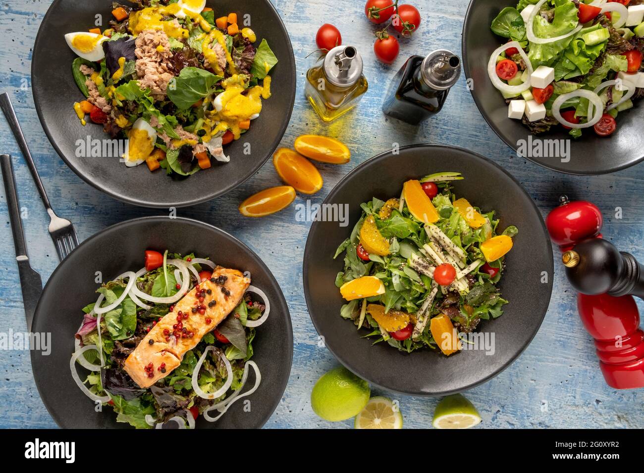 Four different types of salads served freshly on blue stone table Stock ...