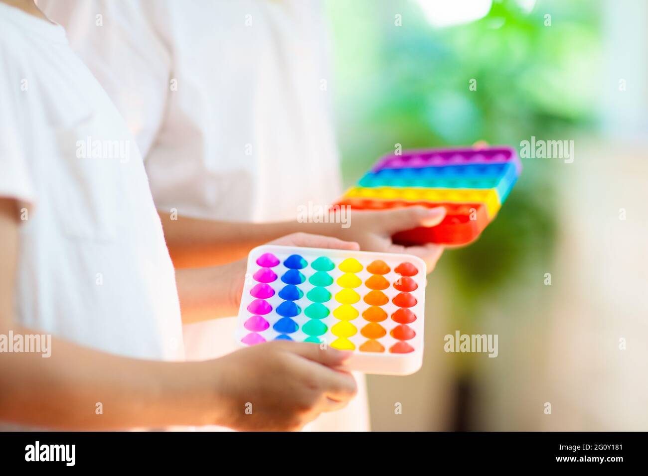 Kids play with pop it sensory toy. Stress and anxiety relief. Trendy ...