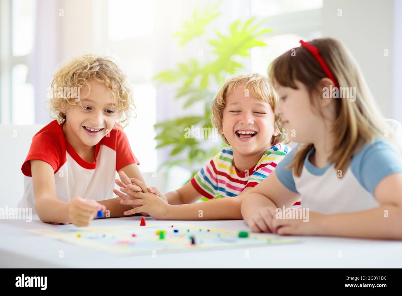 Family playing board game at home. Kids play strategic game. Little boy ...