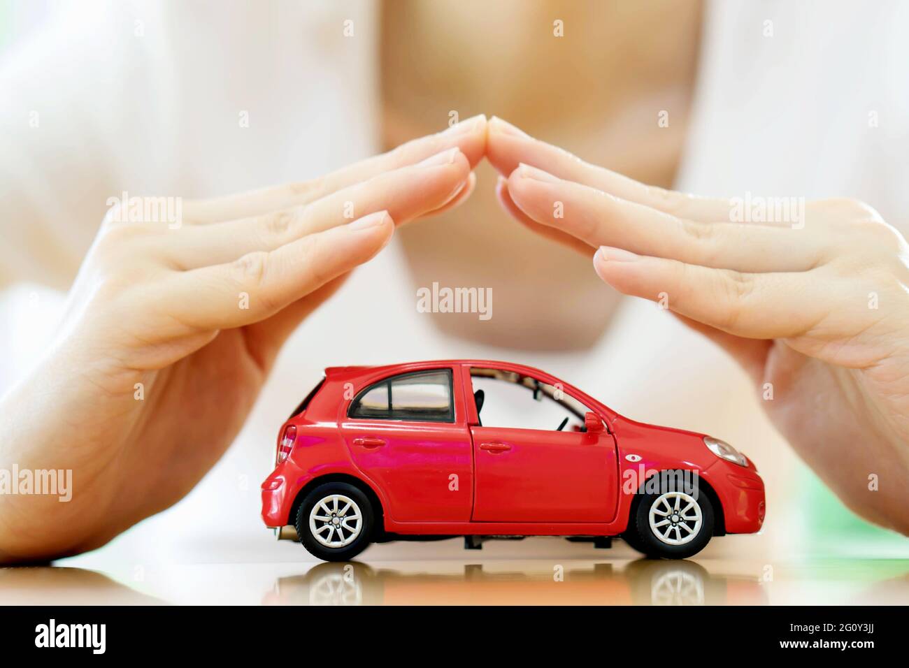 Female hands and car as protection of car concept Stock Photo - Alamy