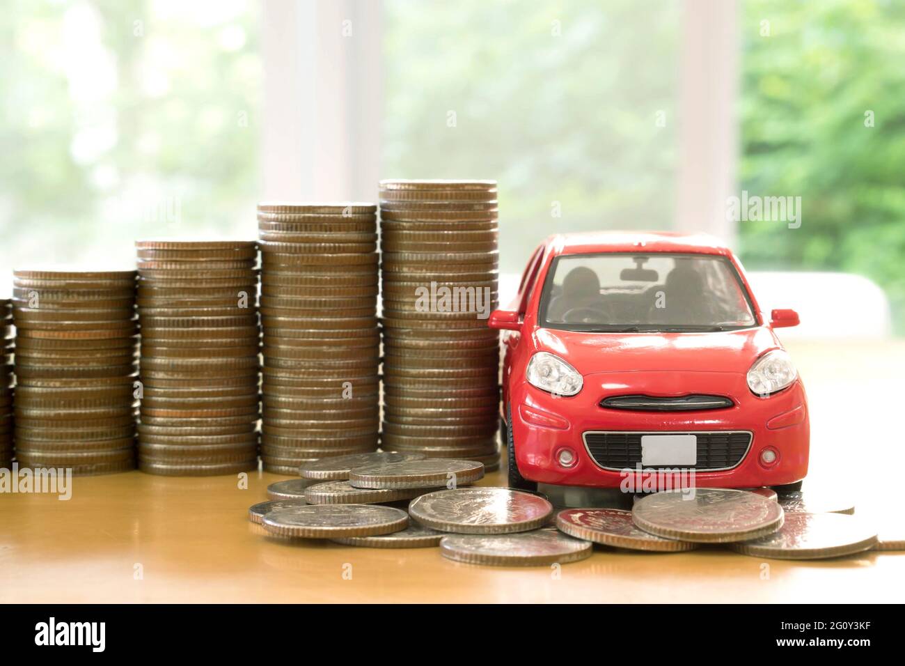 red car over a lot of stacked coins Stock Photo - Alamy
