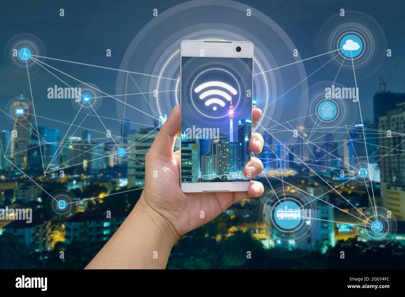 Hand holding white phone with city scape and wifi network connection ...