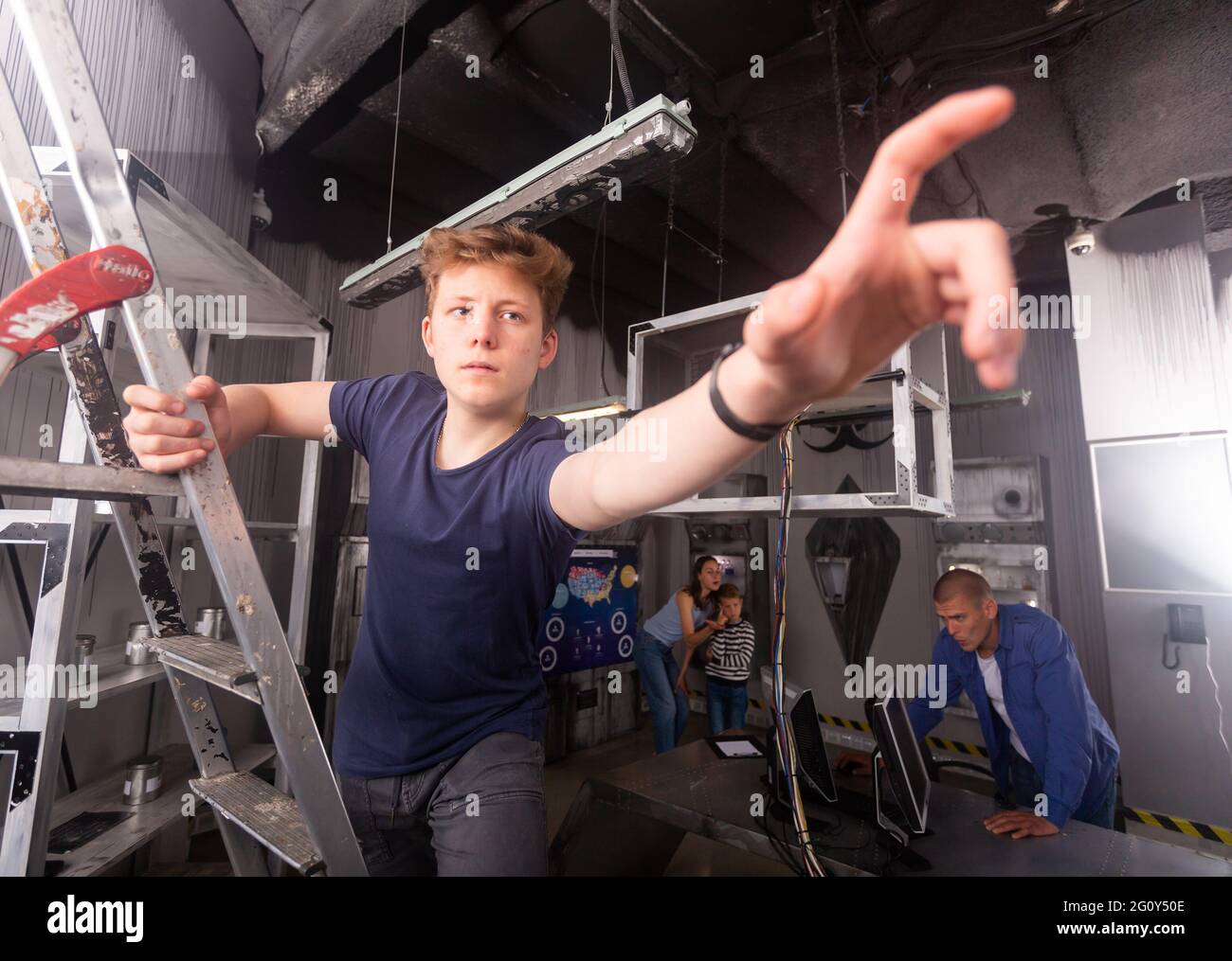 Interested teenage boy reaching for something in quest room Stock Photo ...