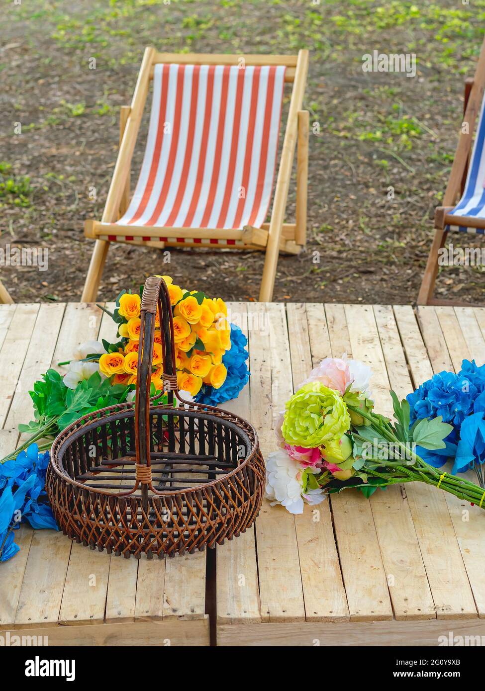 Beautiful artificial bouquets of various colors placed on wooden table ...