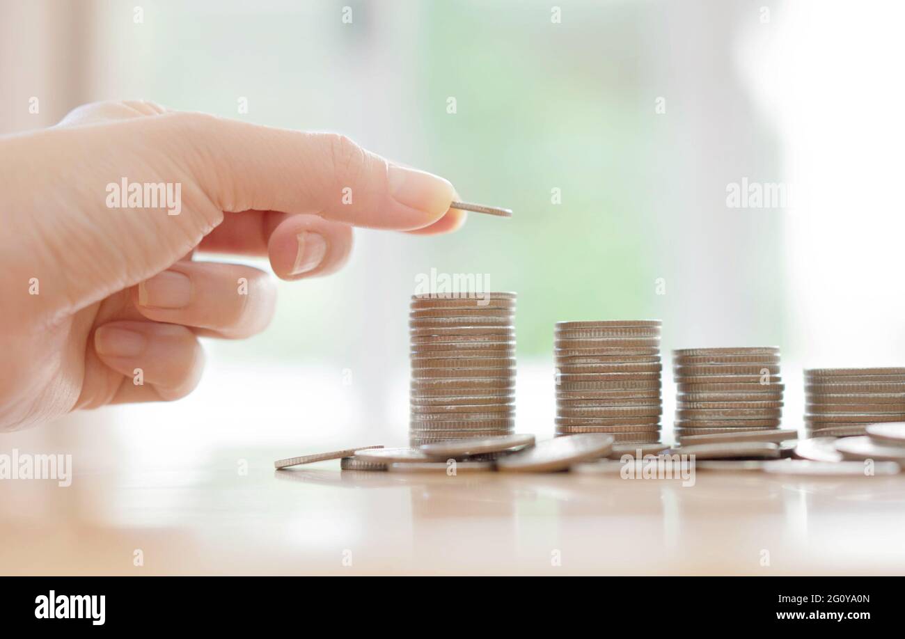 Woman put coins stack hi-res stock photography and images - Alamy