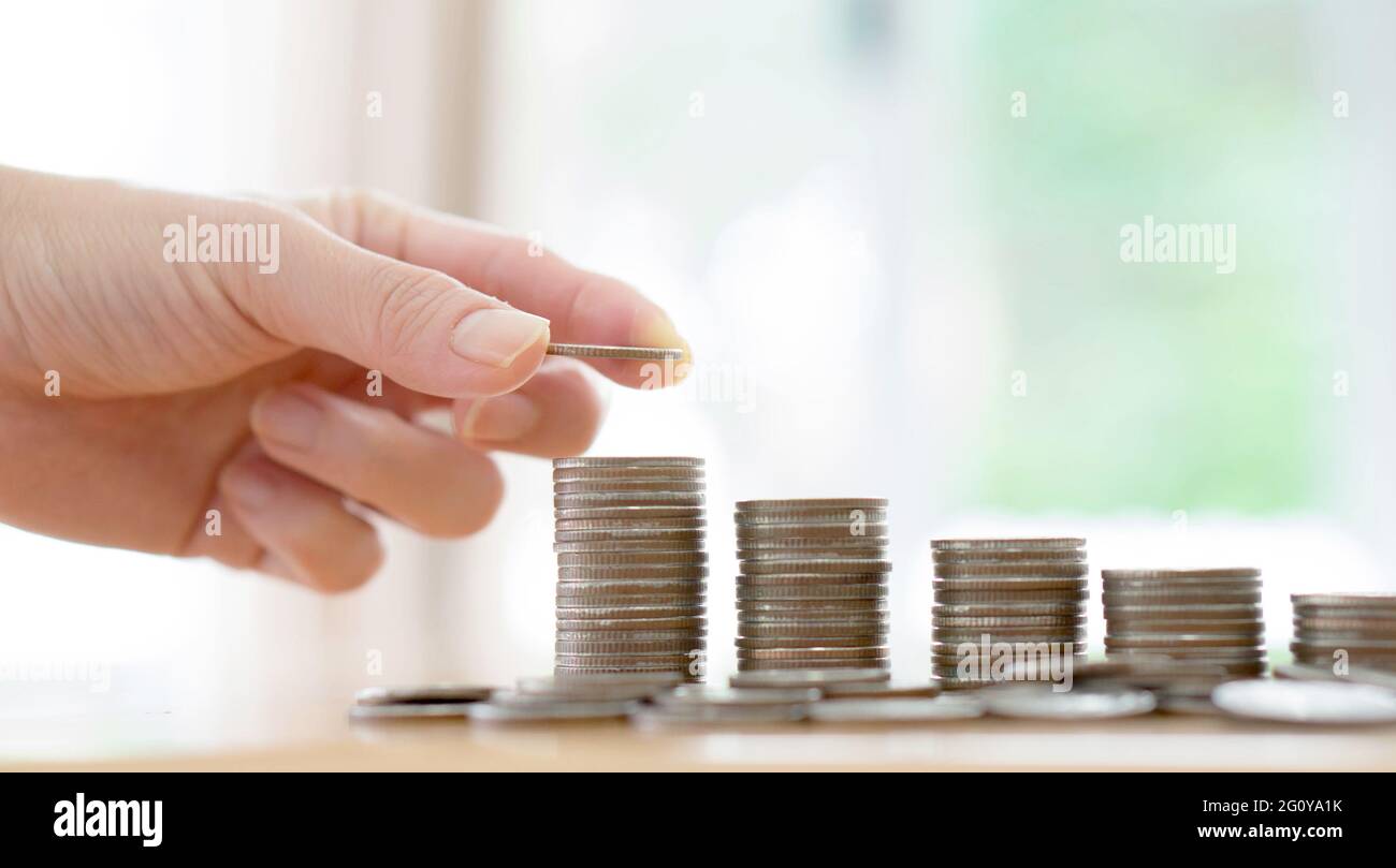 Female hand stack coins hi-res stock photography and images - Alamy