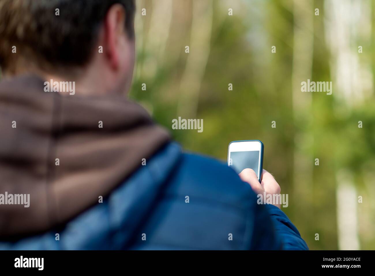 One 40s man with his mobile smart phone searching for reception signal ...
