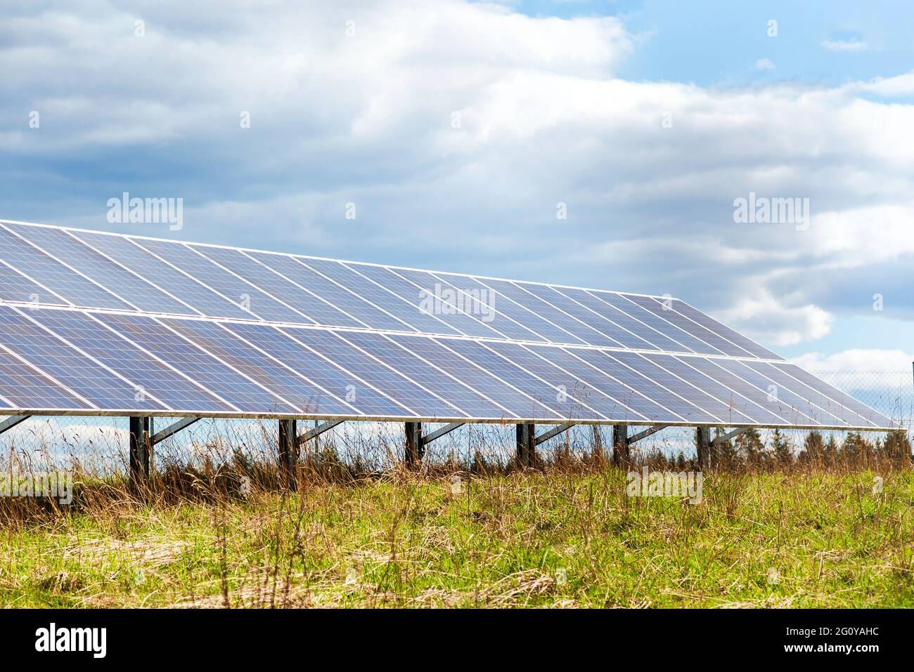 Solar panels in a field.Long line of solar electric generation panels ...