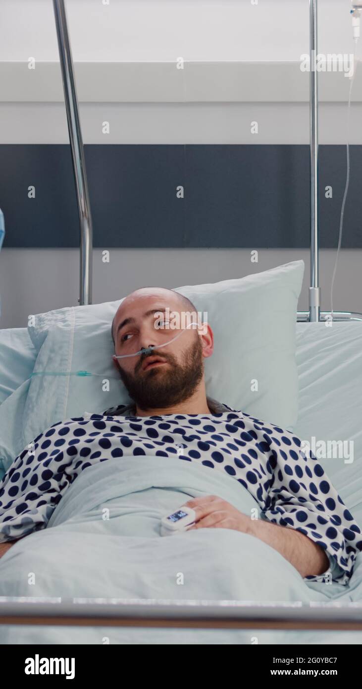 Practitioner nurse monitoring patient during sickness recovery writing ...