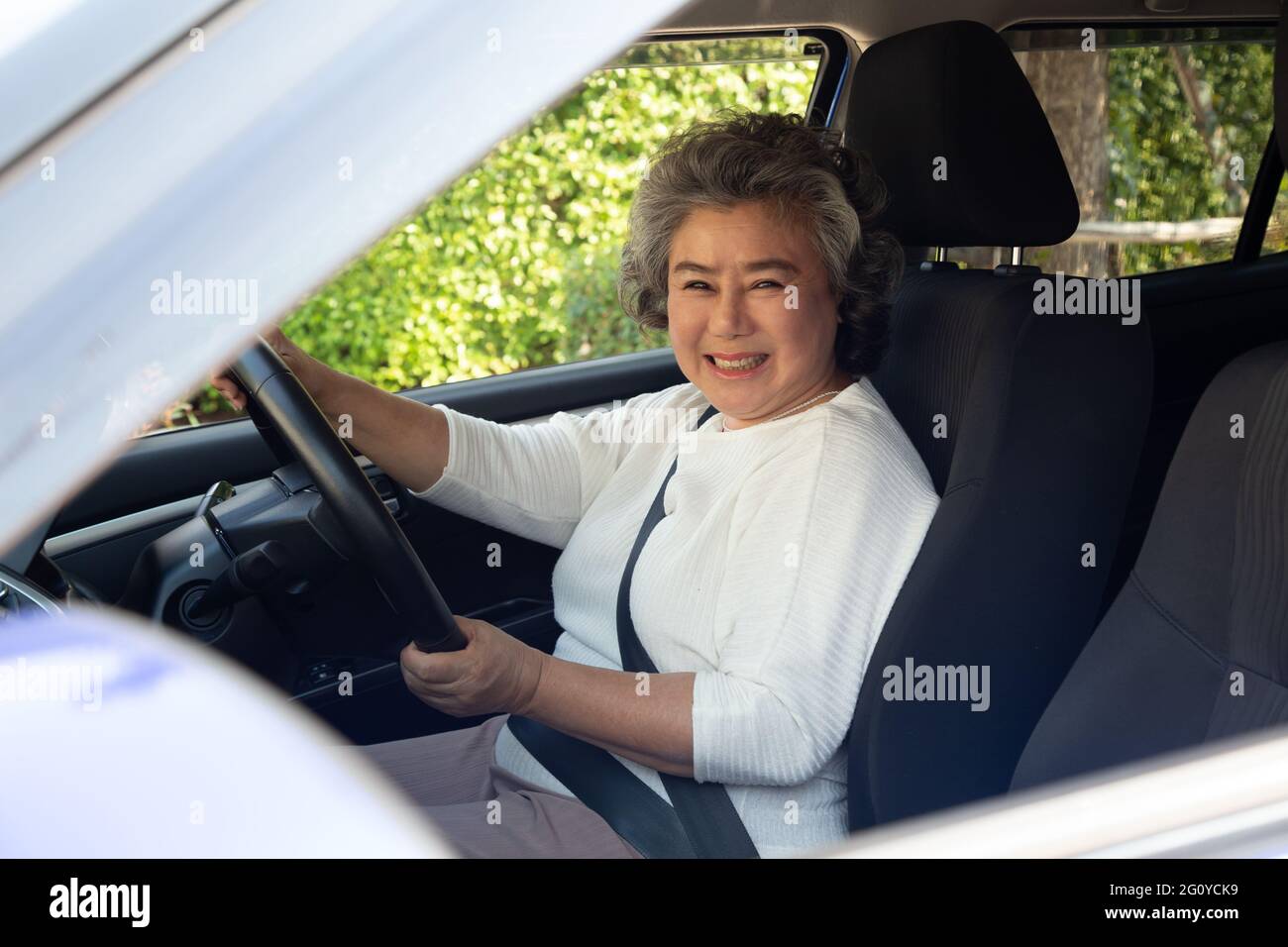Asian senior women driving a car and smile happily with glad positive ...