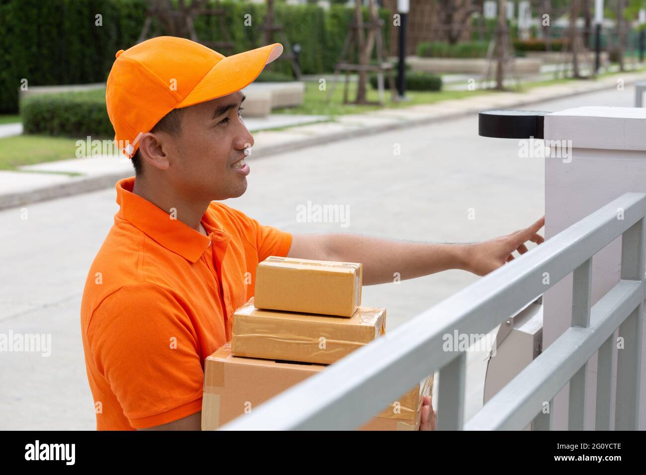 Delivery man ring a bell to call customers for receive a parcel at ...