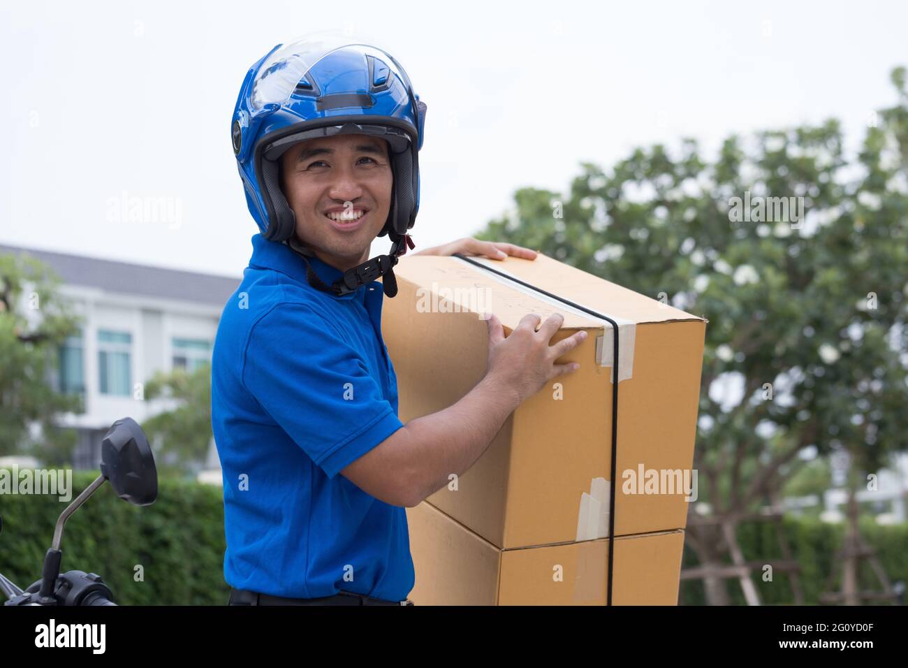 Delivery boy on scooter with parcel box driving fast in rush. Courier ...