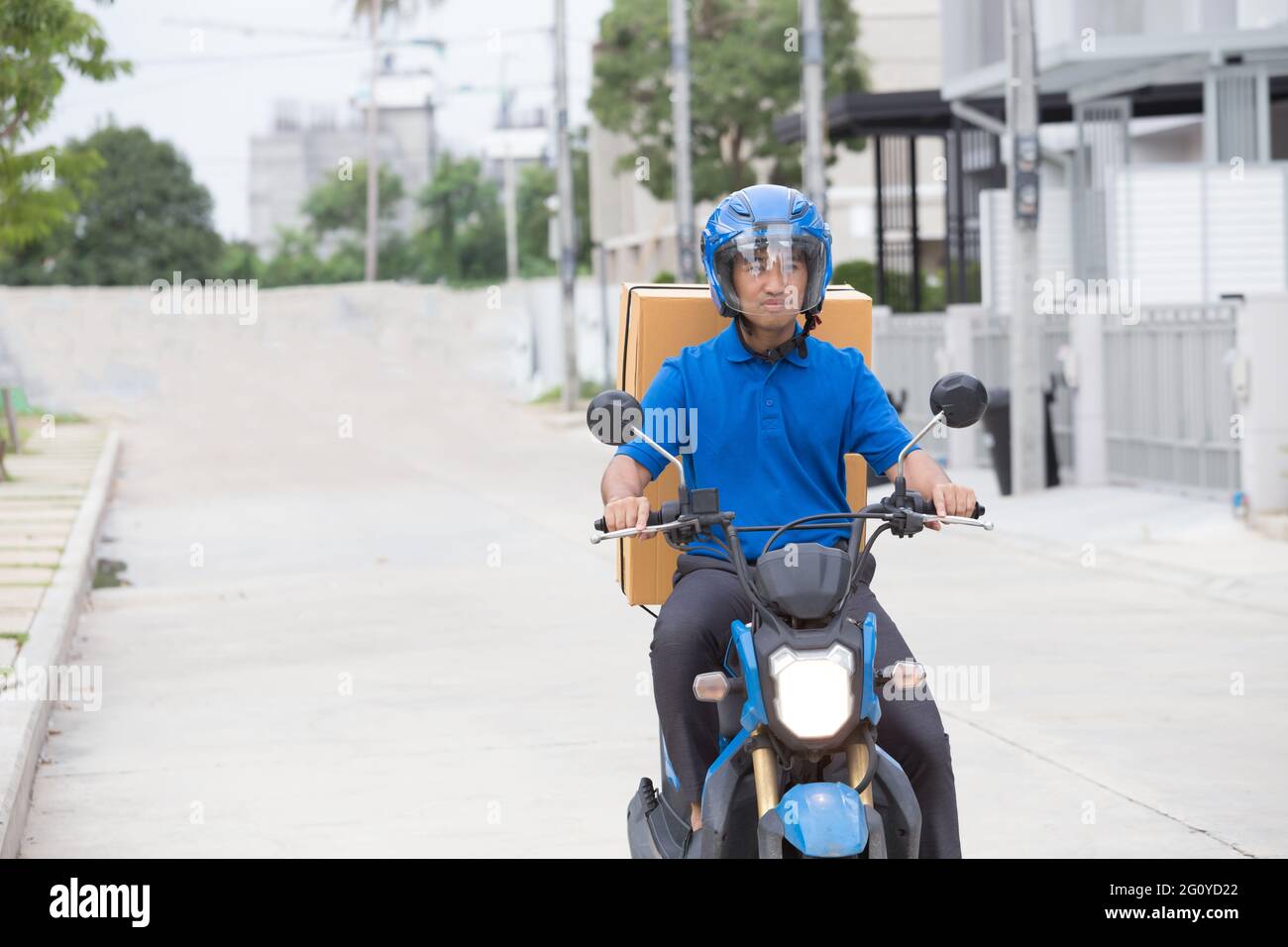 Courier delivering parcel box by motorcycle or scooter. Fast express ...