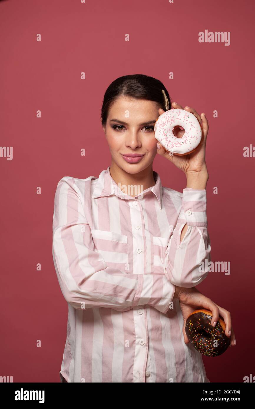 Portrait of smiling woman with fancy smile, having fun with doughnut ...