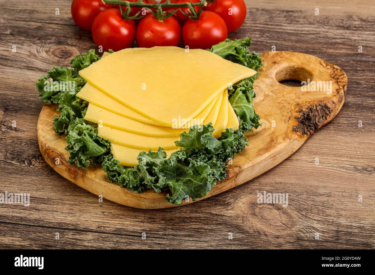 Sliced Gauda cheese snack over board Stock Photo - Alamy