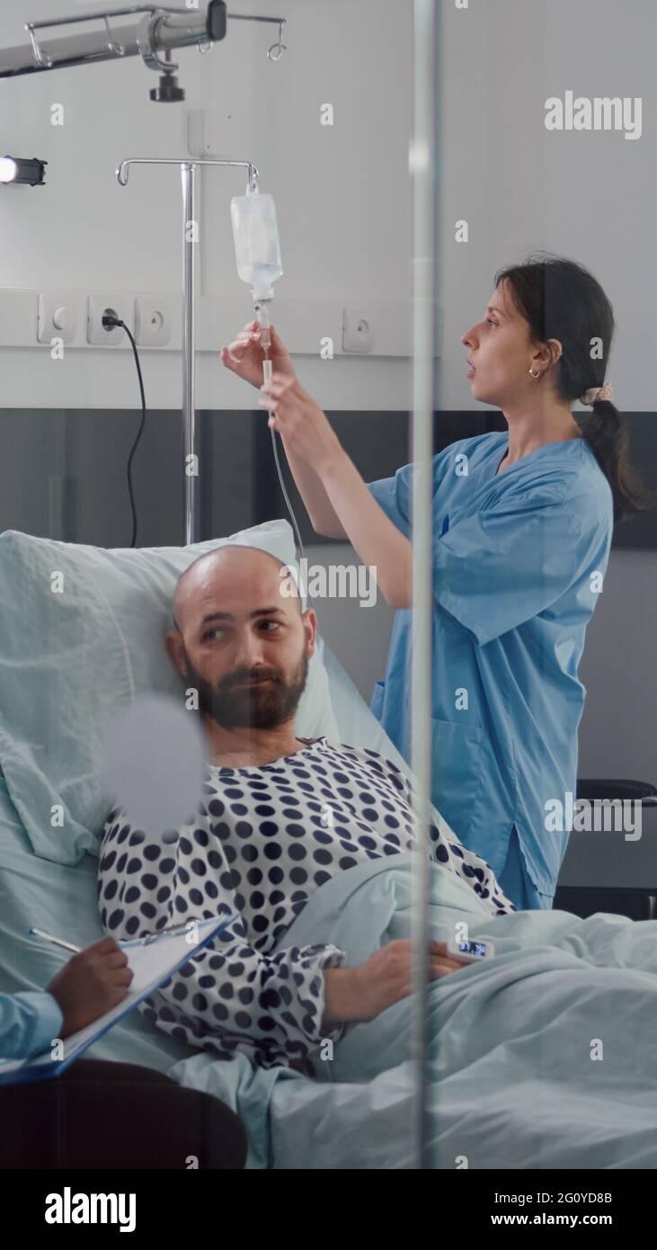 Medical team monitoring patient vital checking heart rate injecting ...