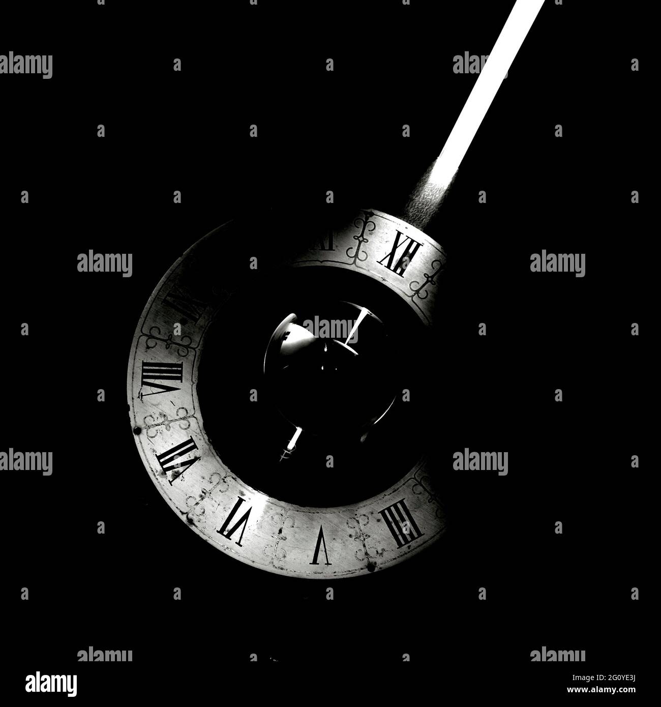 A vintage clock with a bright ray of light in black and white Stock ...