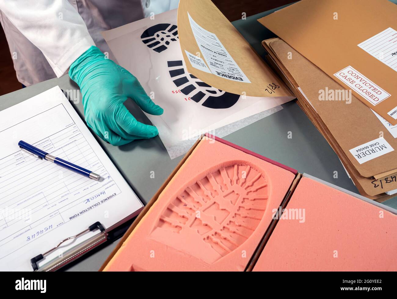Forensic scientist investigates shoeprint mould evidence in crime lab ...