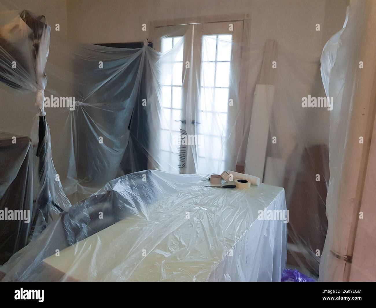 Home during renovation, room ready for renovation covered with plastic ...