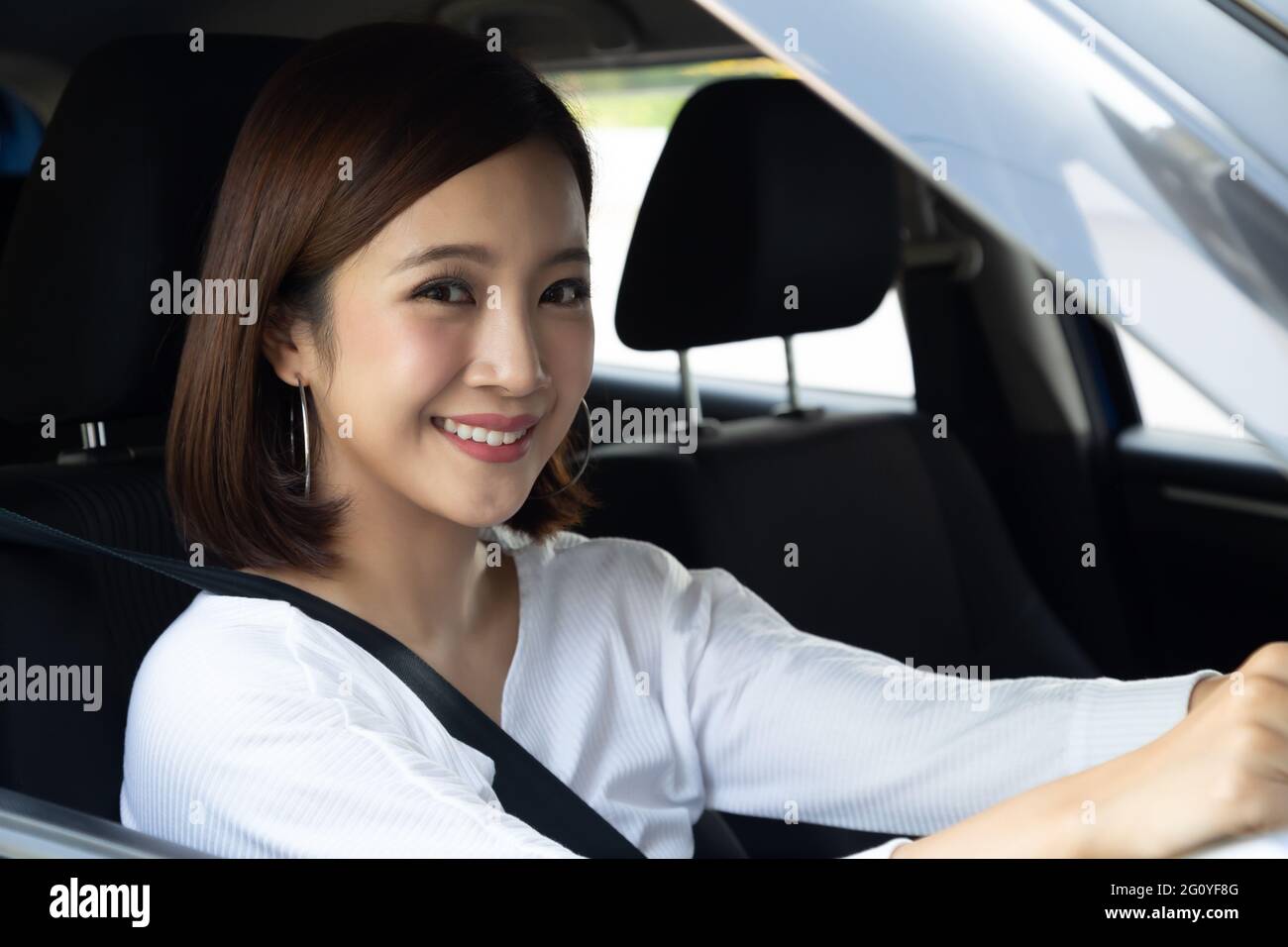 Asian women driving a car and smile happily with glad positive ...