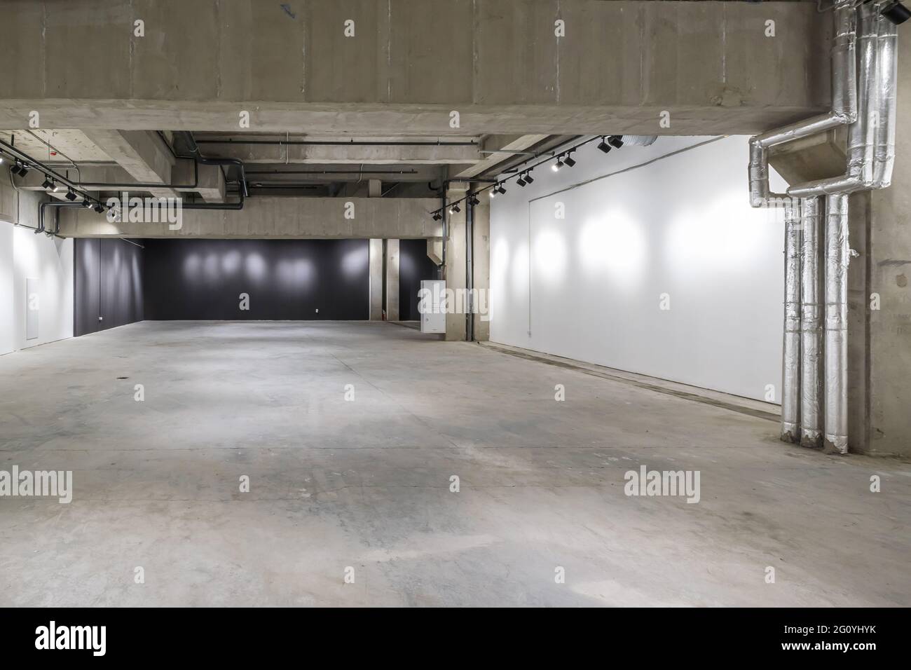 empty interior of large concrete room as warehouse or hangar with ...