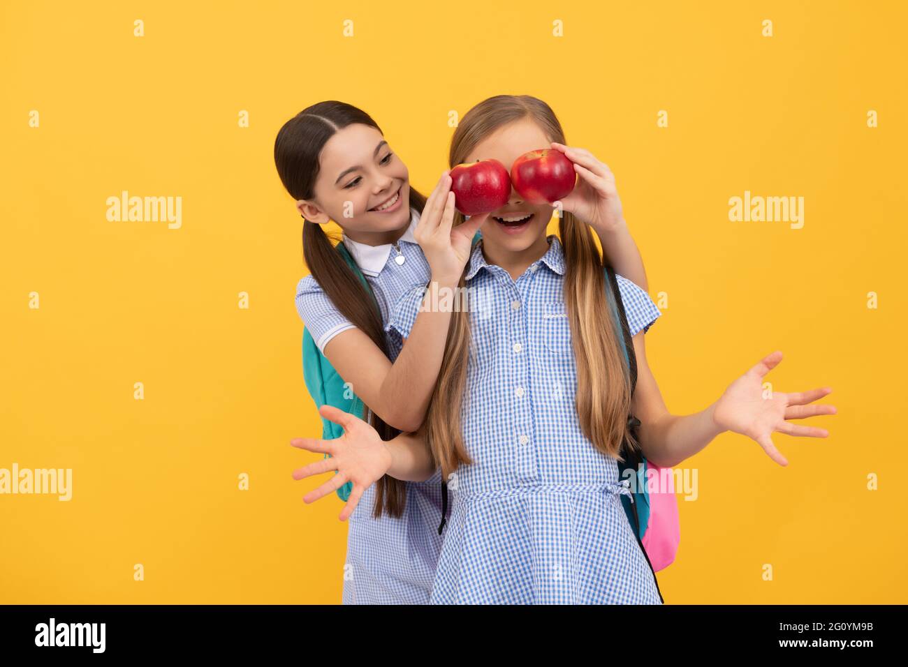Fruit for the fruity face. Happy friends have fun with apples. Fruit ...