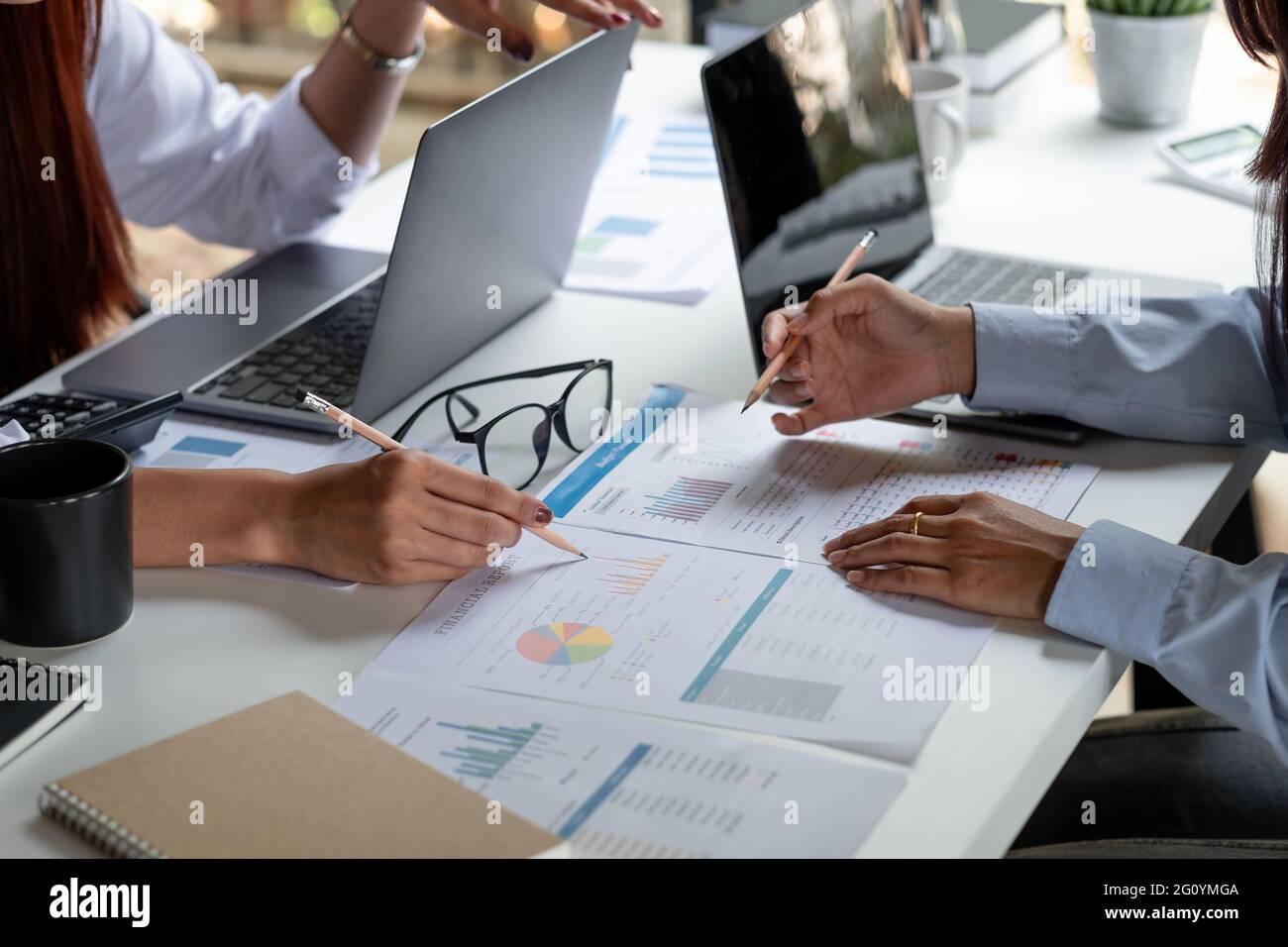 Business people discussing the charts and graphs showing the results of ...