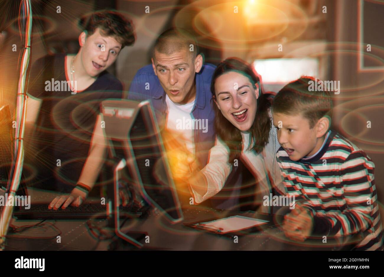 Happy family using computer in closed escape room stylized as bunker ...