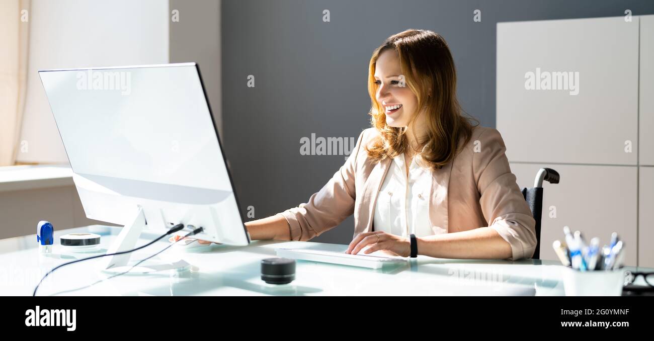 Handicapped Businesswoman Using Desktop Computer At Office Desk Stock ...