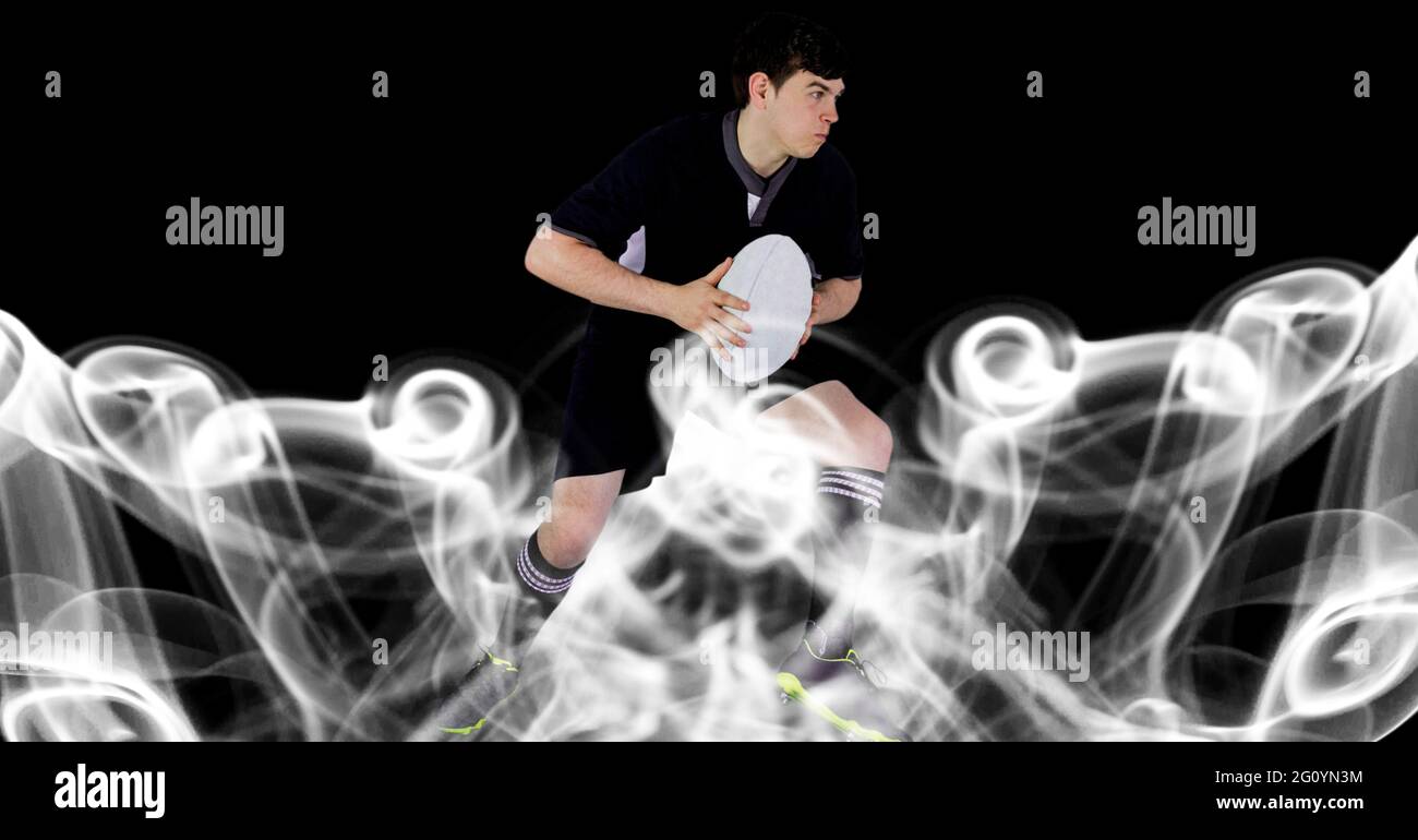 Compostion of caucasian rugby player holding ball on black background ...