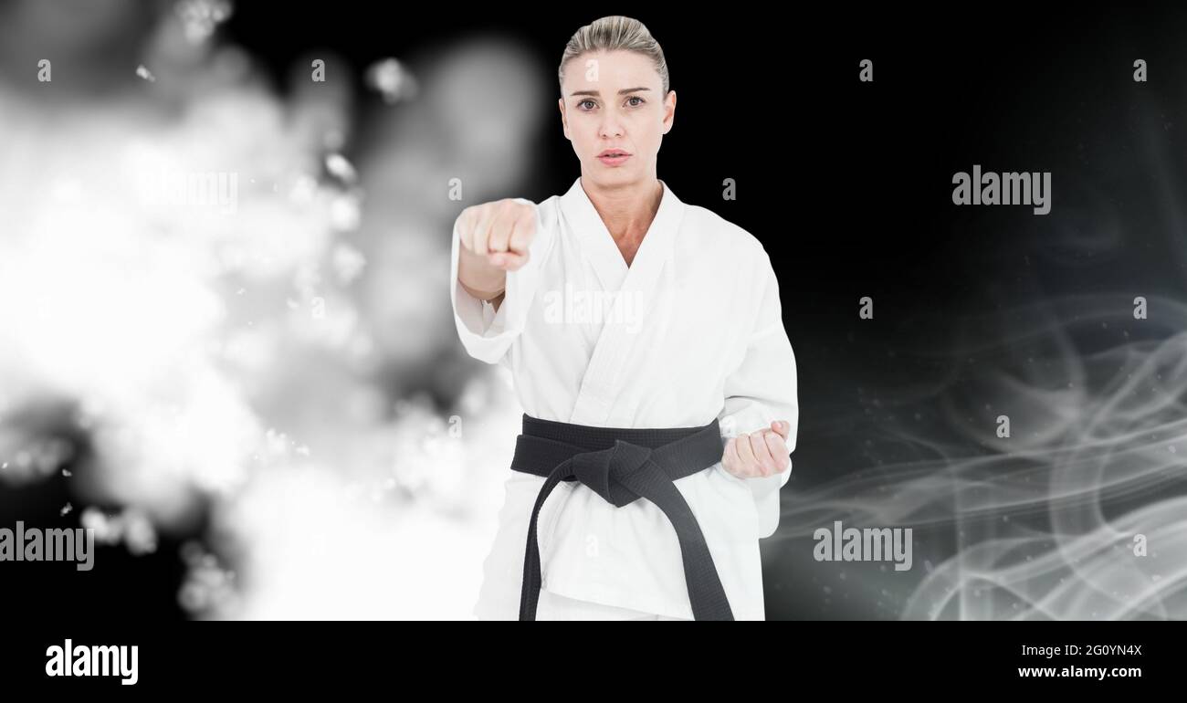 Compostion of caucasian female karate fighter on black background with ...