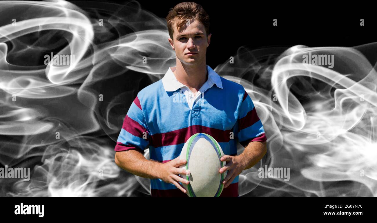 Compostion of caucasian rugby player holding ball on black background ...