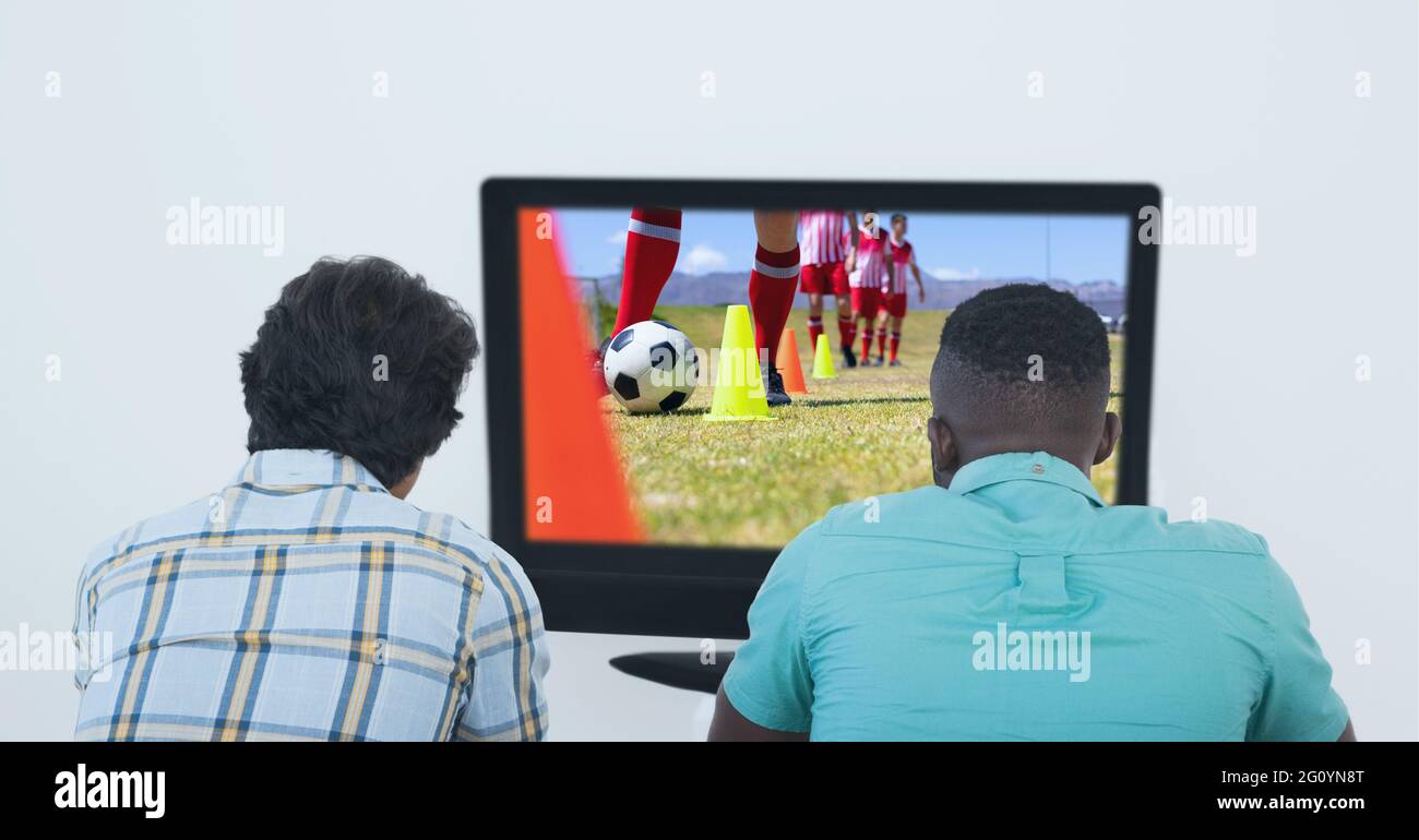 Compostion of diverse male friends watching football match on tv on ...