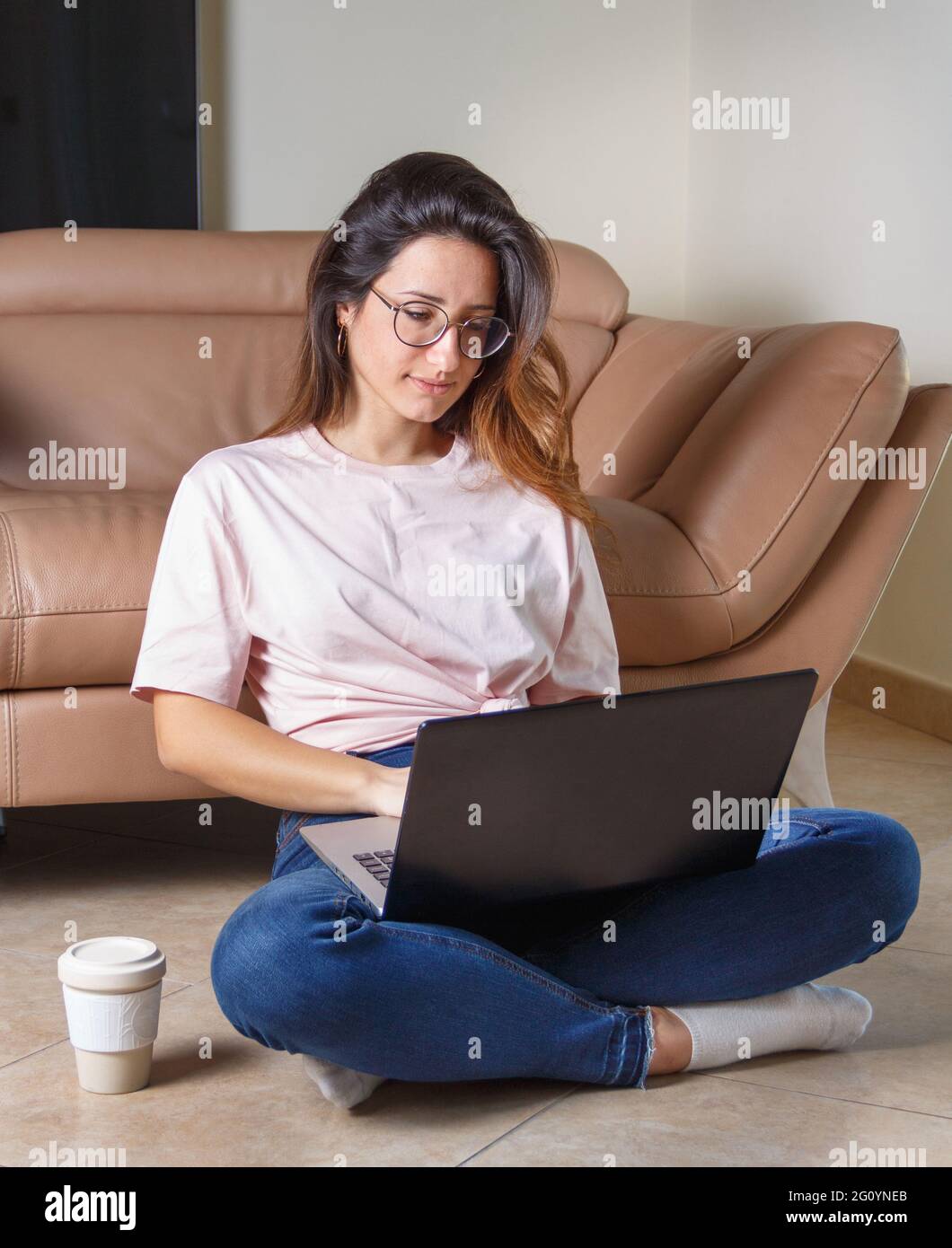Young women using laptop while sitting on the floor at home Stock Photo ...