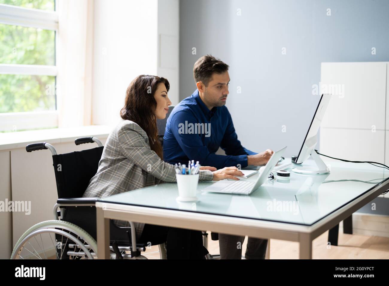 Meeting And Discussion At Office Desk. Handicapped Young Worker Stock ...