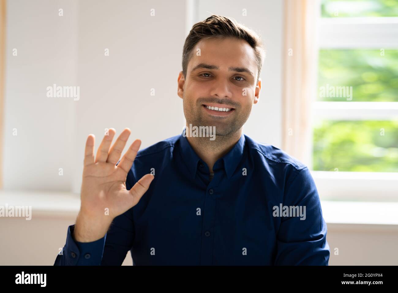 Man Portrait Waving Hello In Video Conference Stock Photo - Alamy