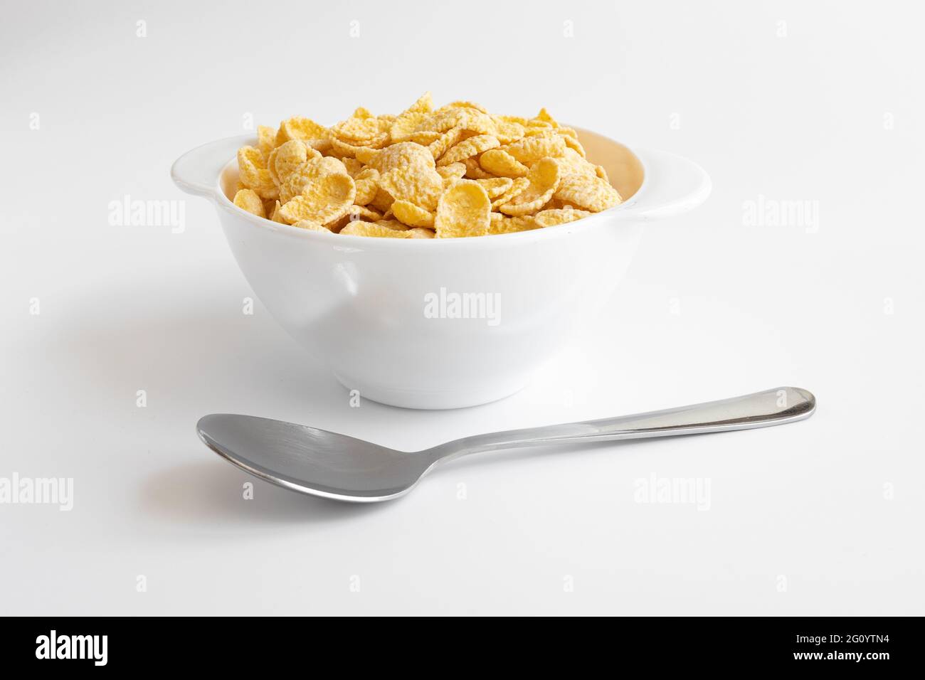 corn flake in bowl and spoon near isolated on white background, plate ...
