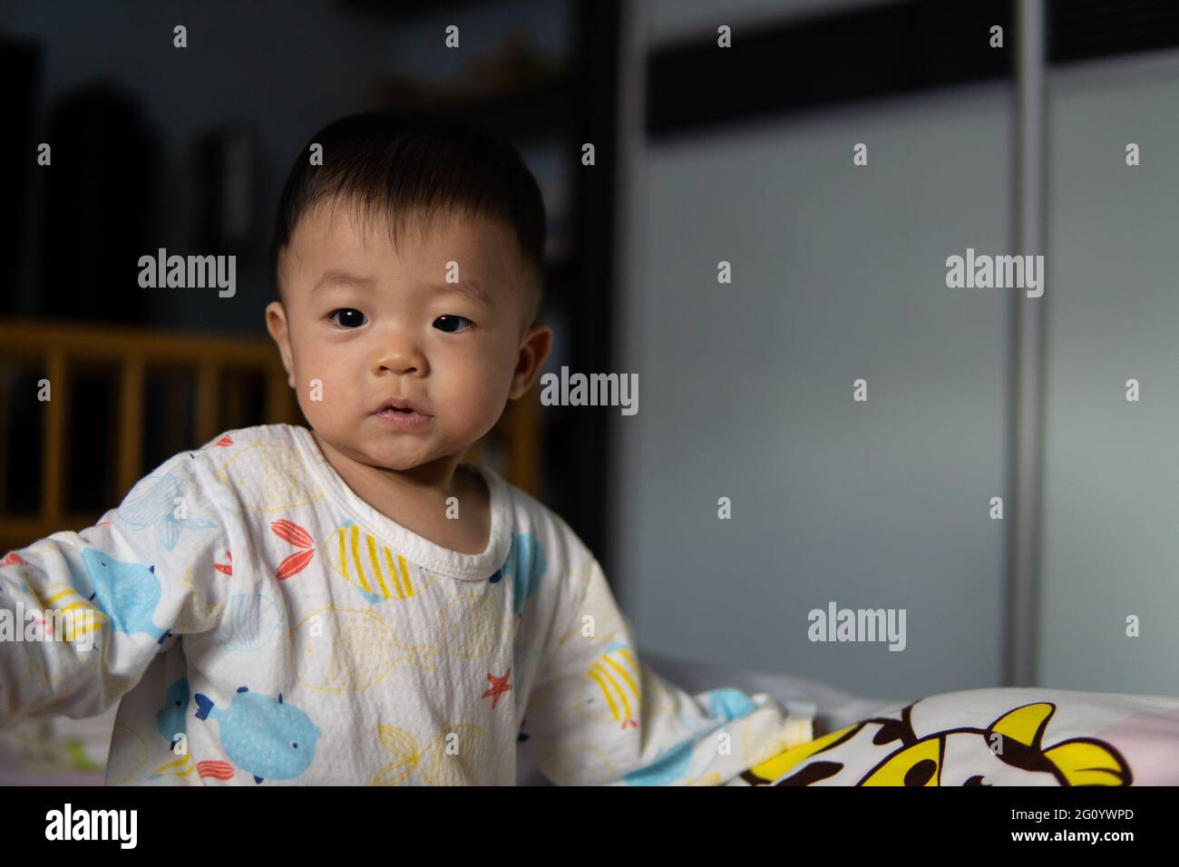 Portrait image of adorable and lovely asian boy just wake up during ...