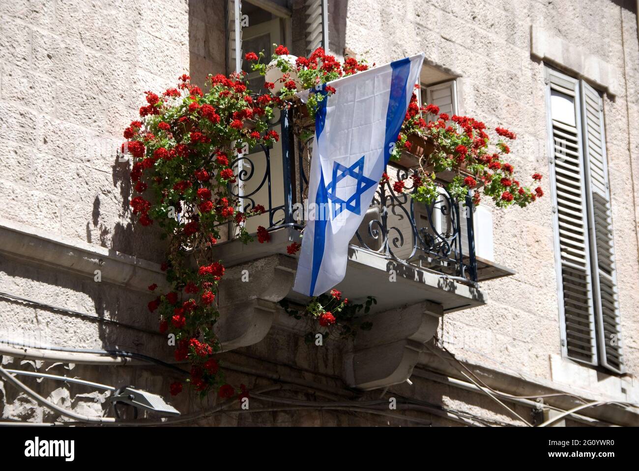 Flag of Isreal hanging on a balcony in Jerusale Stock Photo - Alamy