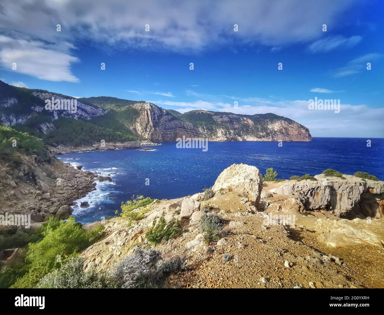 stone beach in mallorca with a cliff Stock Photo - Alamy
