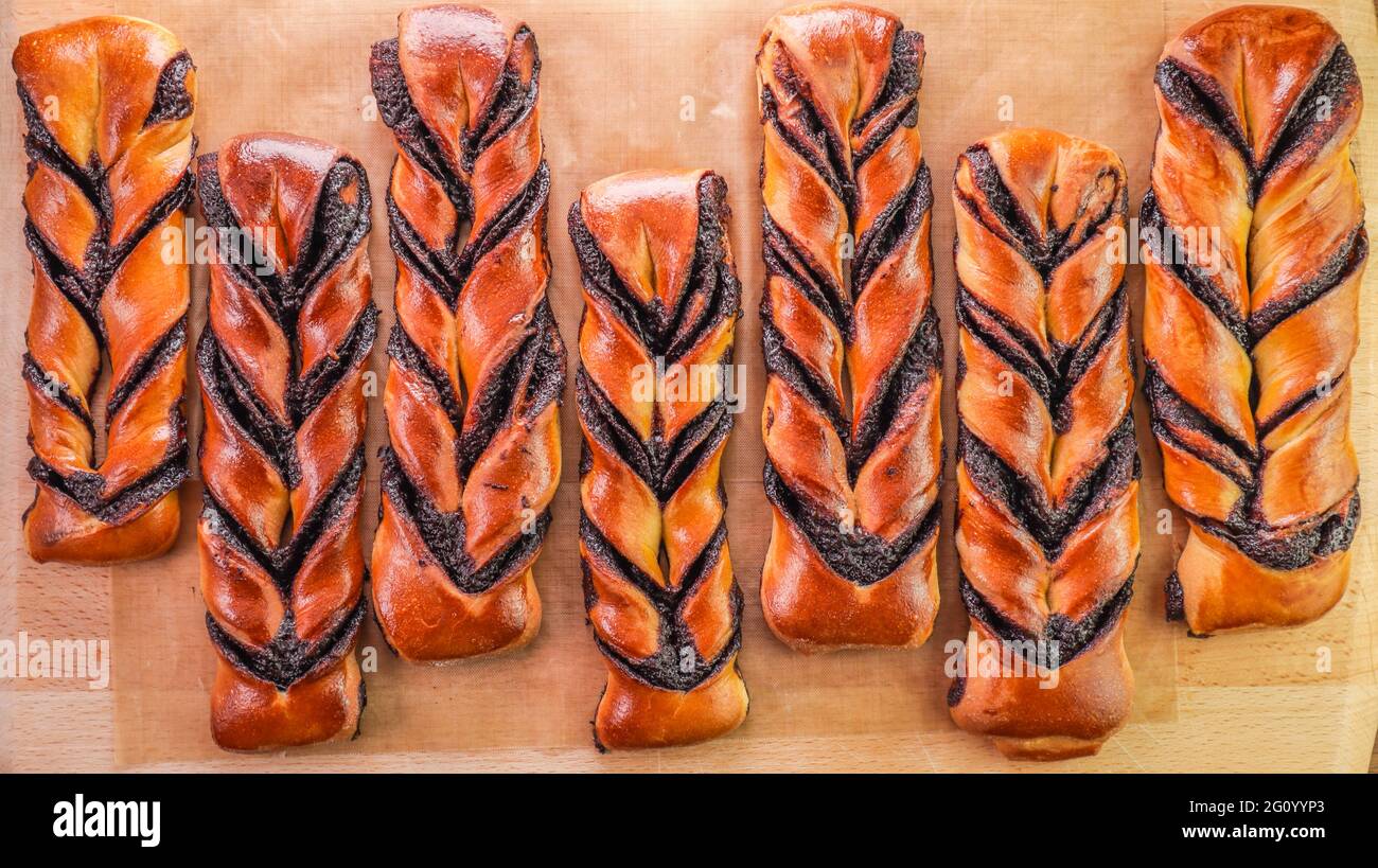 Top view of freshly baked twists layered chocolate buns on a wooden ...