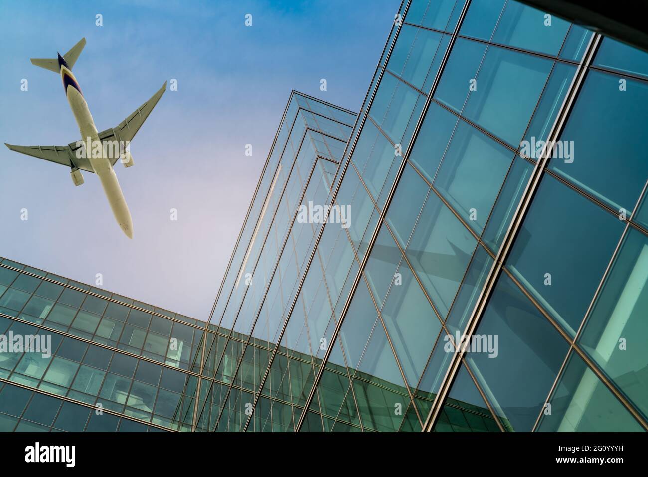 Airplane flying above office building. Skyscraper modern building ...