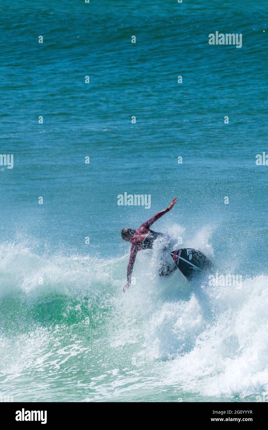 Spectacular surfing action as a surfer rides the crest of a wave at ...