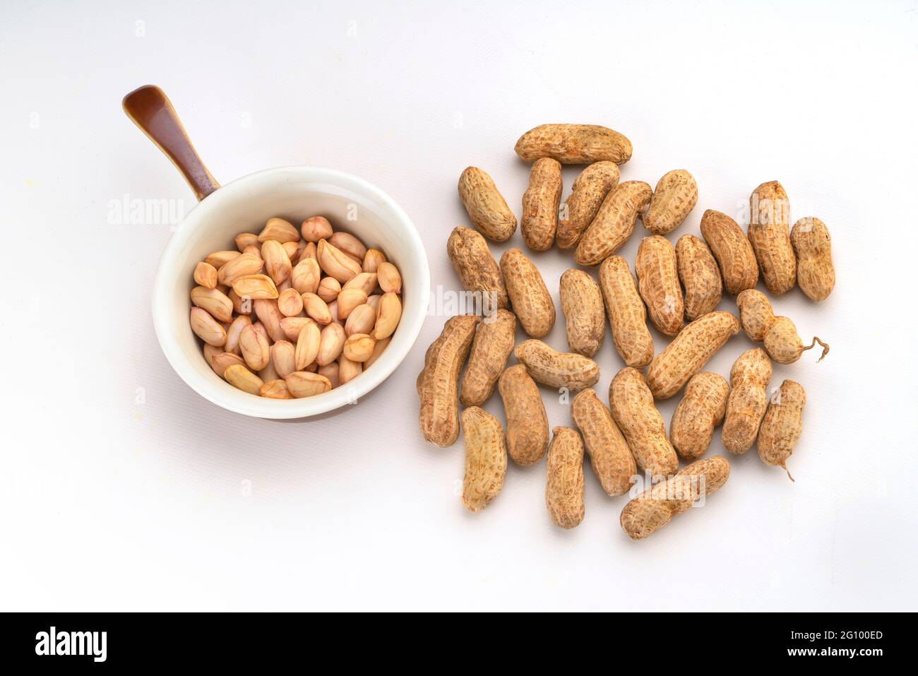 Closeup top view of raw groundnuts, peanuts, Arachis hypogaea with ...