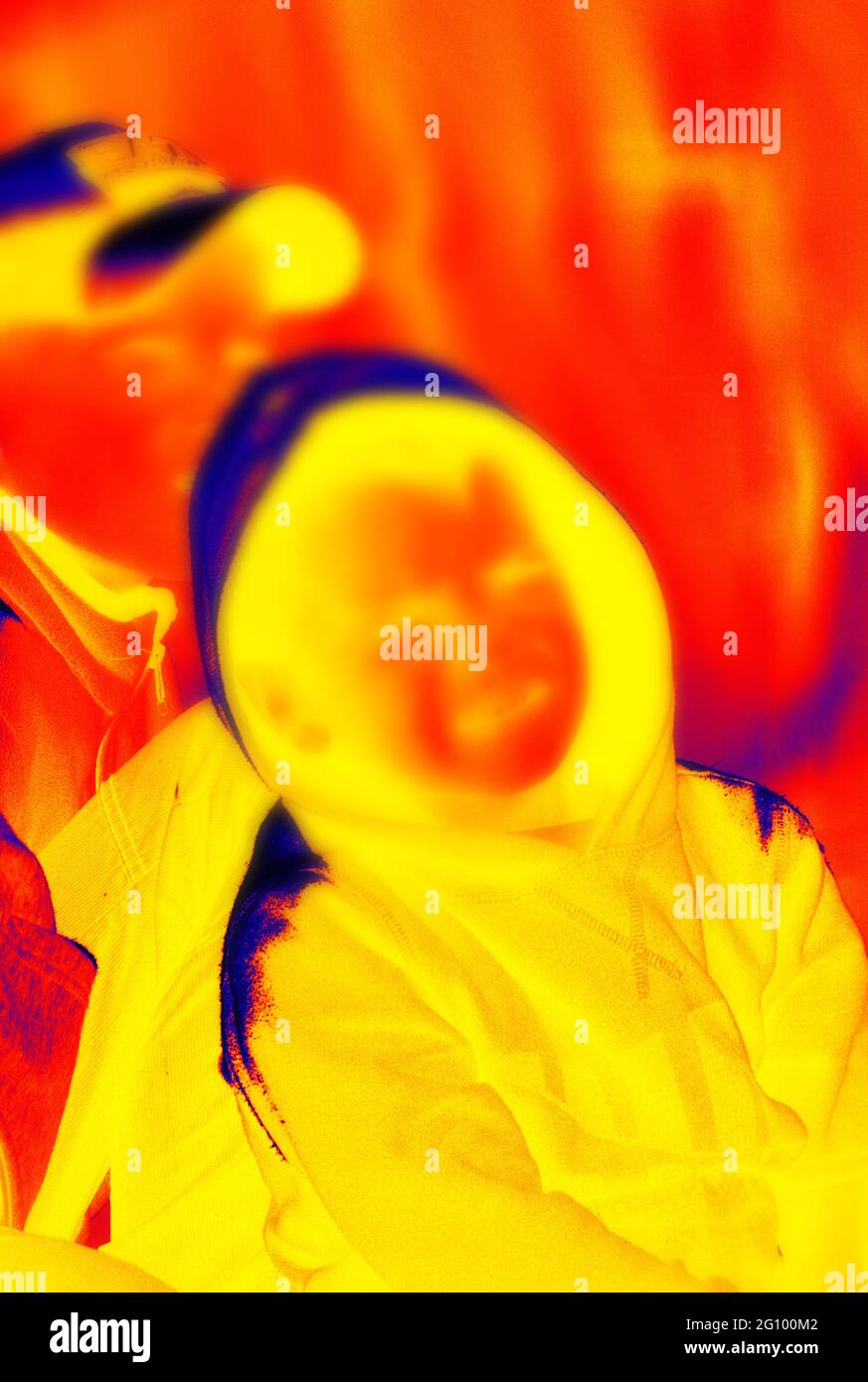 People on the night street. Scanning human's body temperature with ...