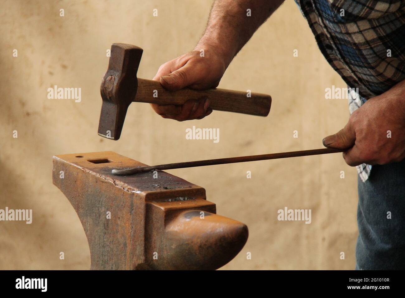 A Blacksmith Shaping a Piece of Metal with a Hammer Stock Photo - Alamy