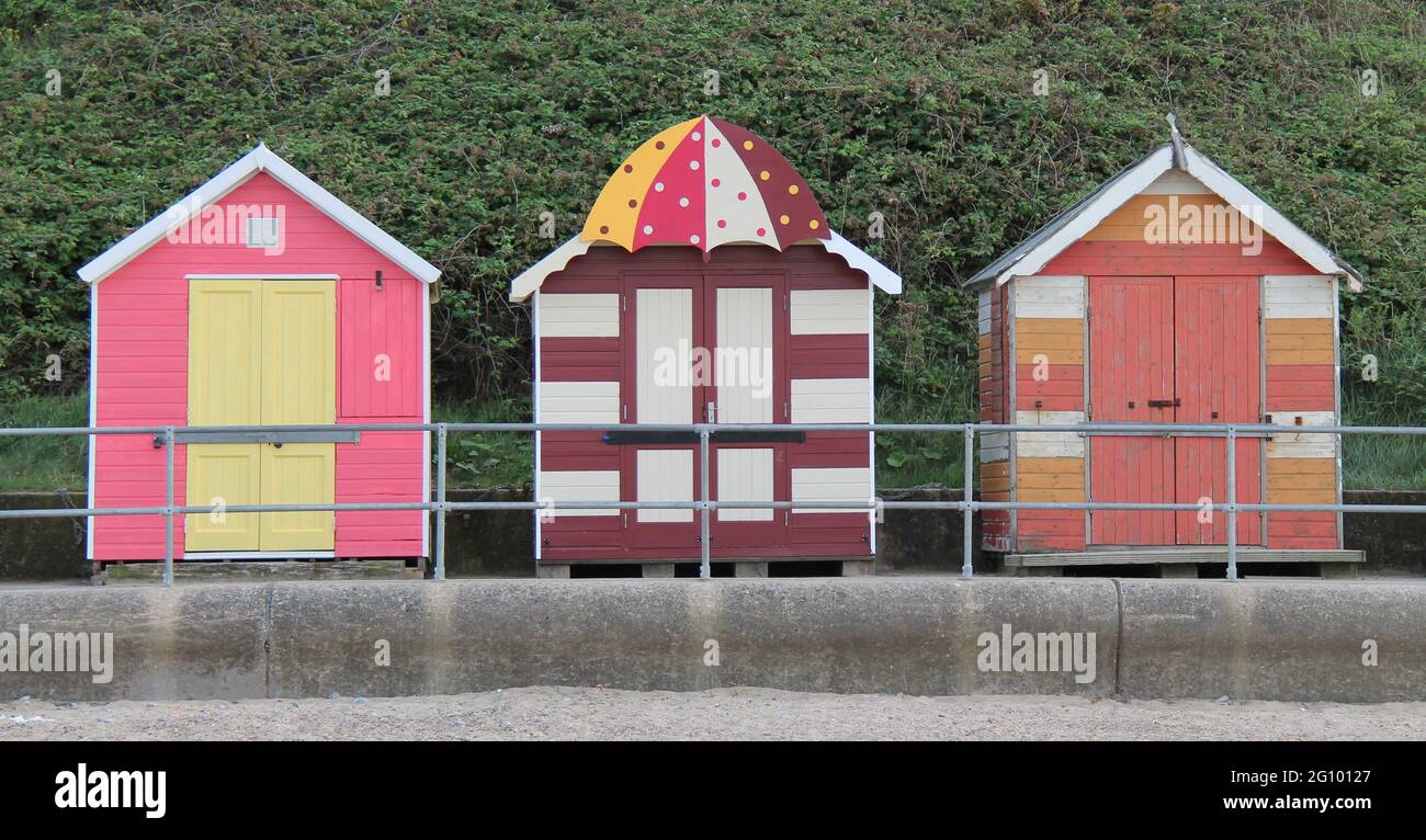 A Contrast of Three Different Wooden Beach Huts Stock Photo - Alamy