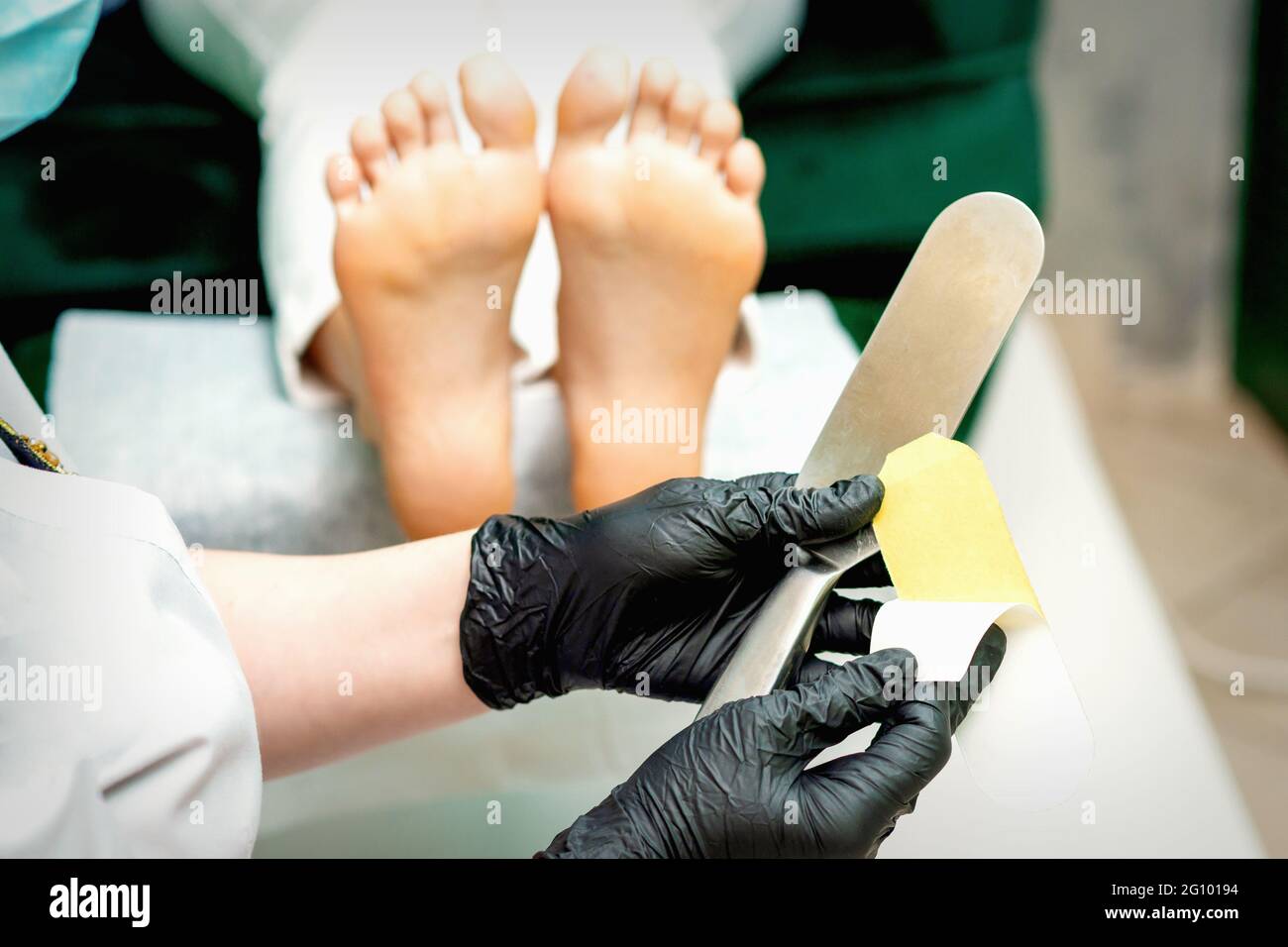 The pedicure master putting on new sandpaper on the metal handle before ...